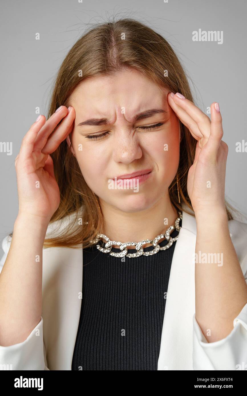 Woman Holding Her Head in Hands in Studio Stock Photo - Alamy
