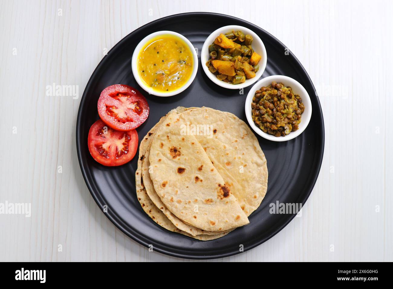 Roti and bhaji. Indian vegetarian Thali or platter includes akhha ...