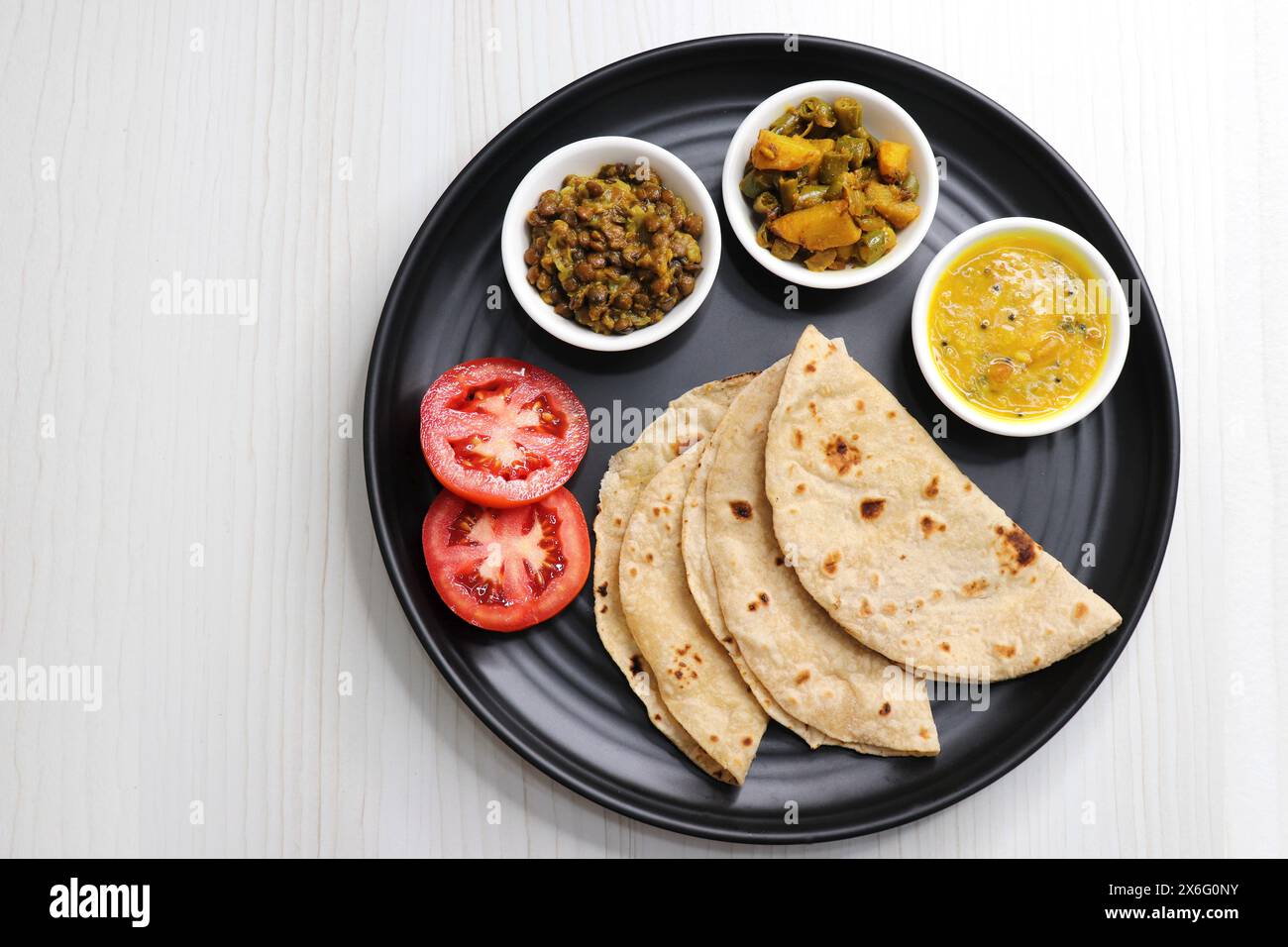Roti and bhaji. Indian vegetarian Thali or platter includes akhha ...