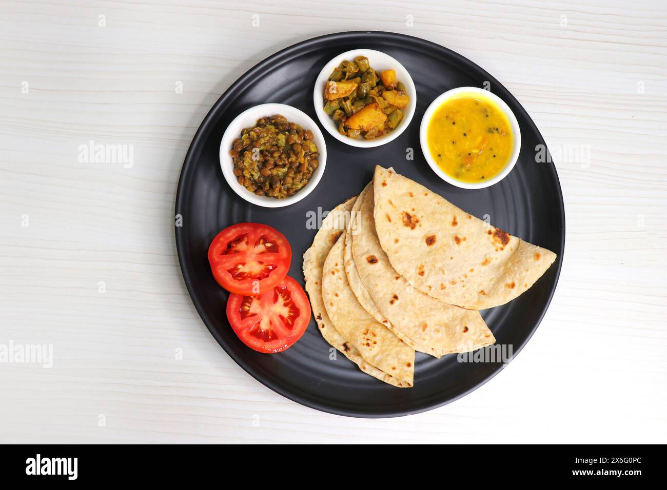 Roti and bhaji. Indian vegetarian Thali or platter includes akhha ...