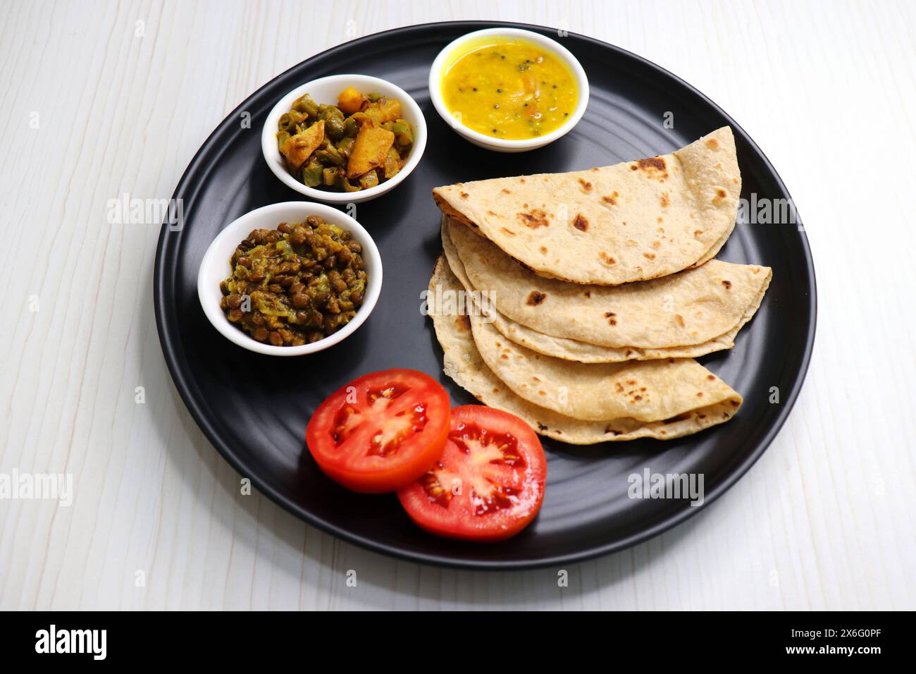 Roti and bhaji. Indian vegetarian Thali or platter includes akhha ...