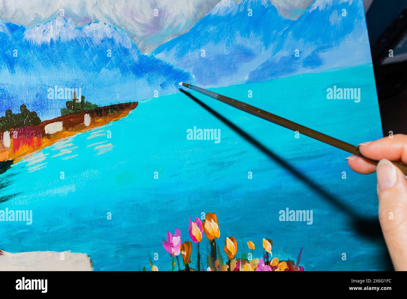 An artist is creating a masterpiece depicting a serene lake surrounded ...