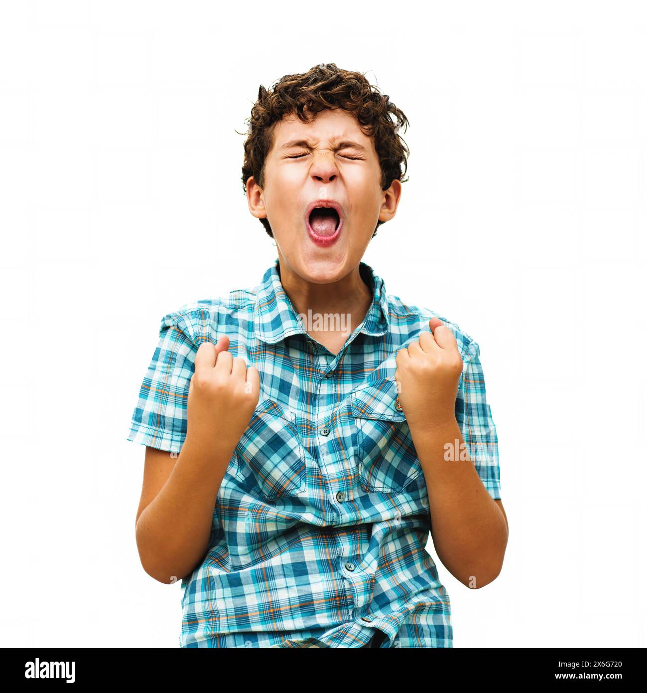 Excited boy cheering with fists raised, wearing a blue and orange plaid ...