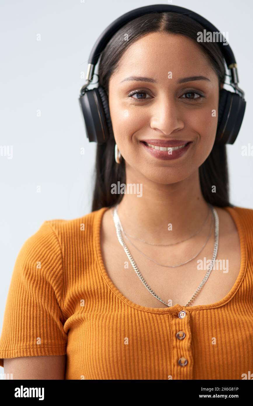 Woman, smile and portrait with headphones in studio background for ...