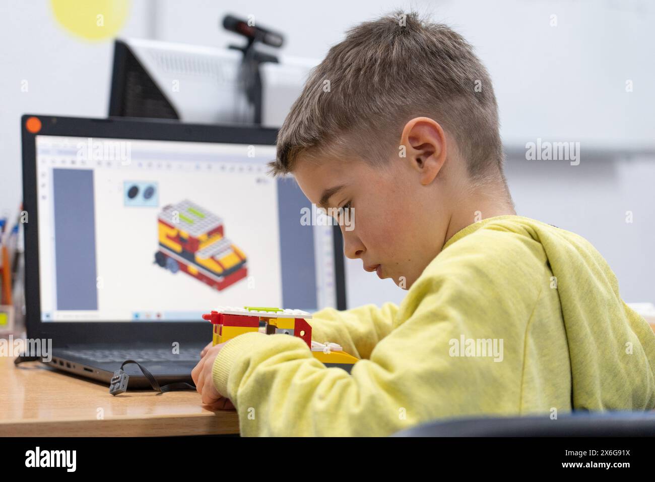 Concentrated child in a robotics workshop building a robot Stock Photo ...