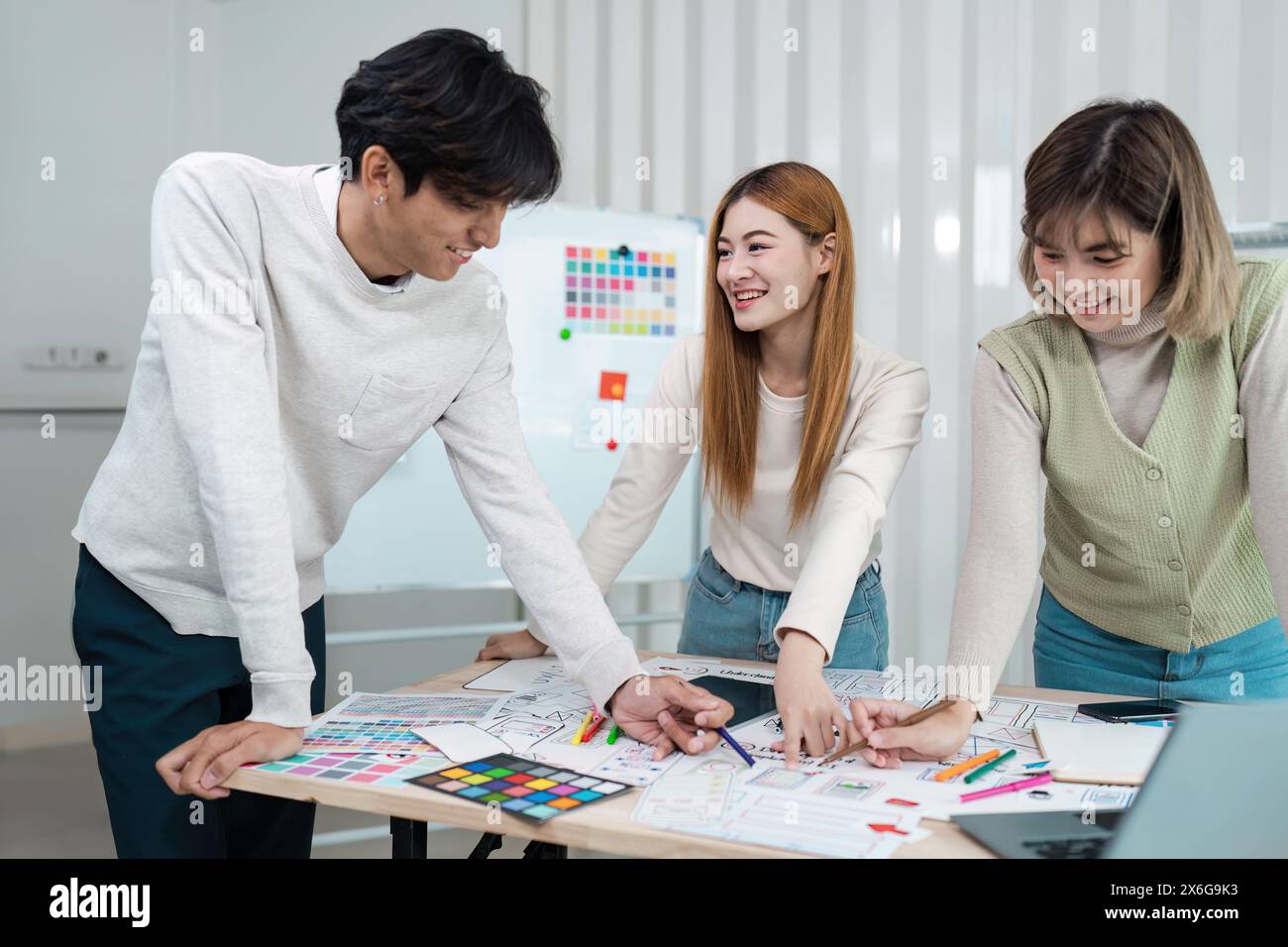 UI designer and UX developer brainstorm idea to design the application ...