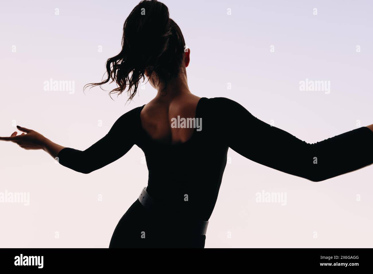 Female dancer with a toned physique and expressive body language ...