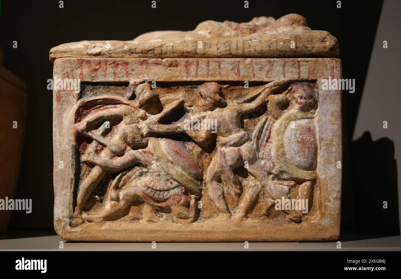 Etruscan funerary urn. Front-panel relief. "Hero fighint with a plow ...