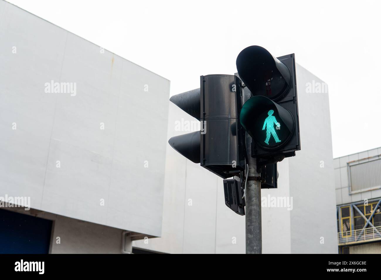 A close-up photo of a traffic light with a green pedestrian signal ...