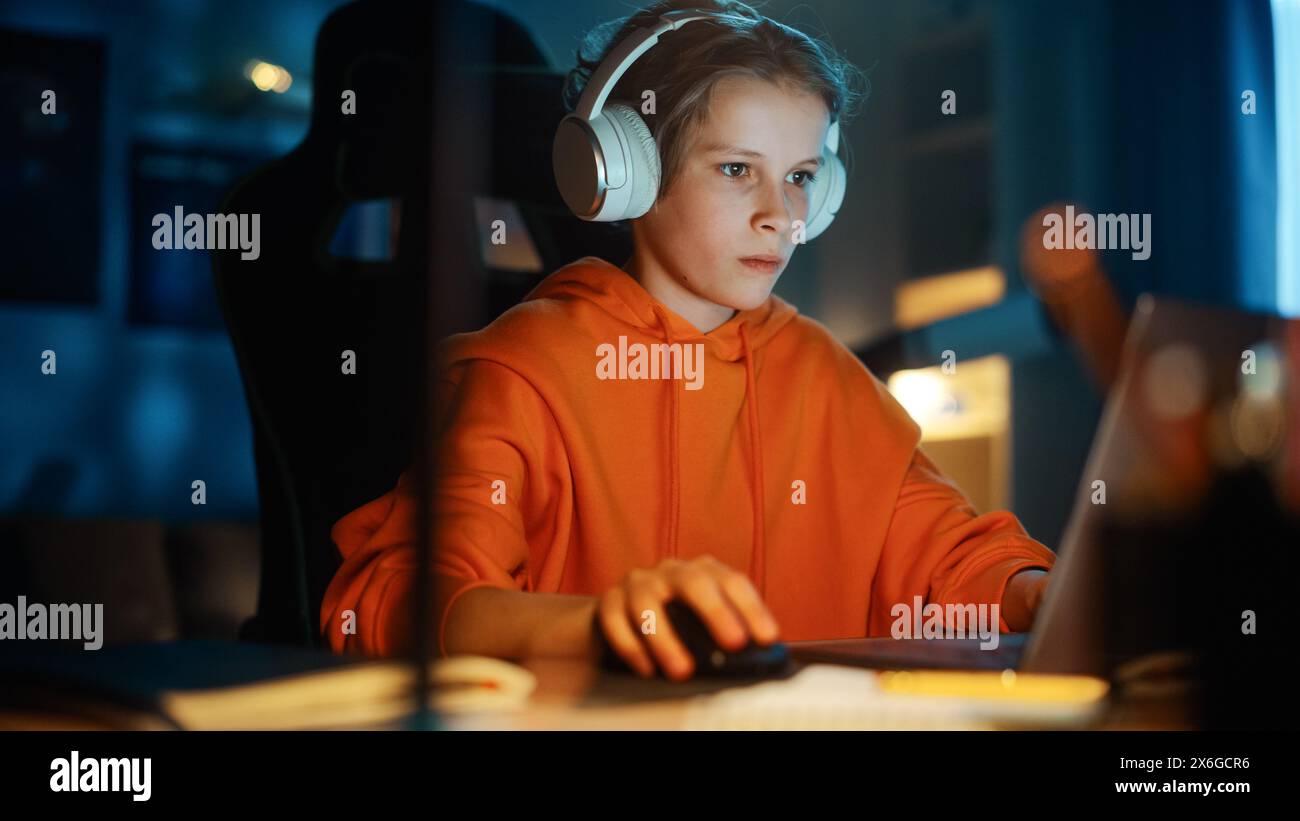 Excited Young Boy in Headphones Playing Video Games on Laptop Computer ...