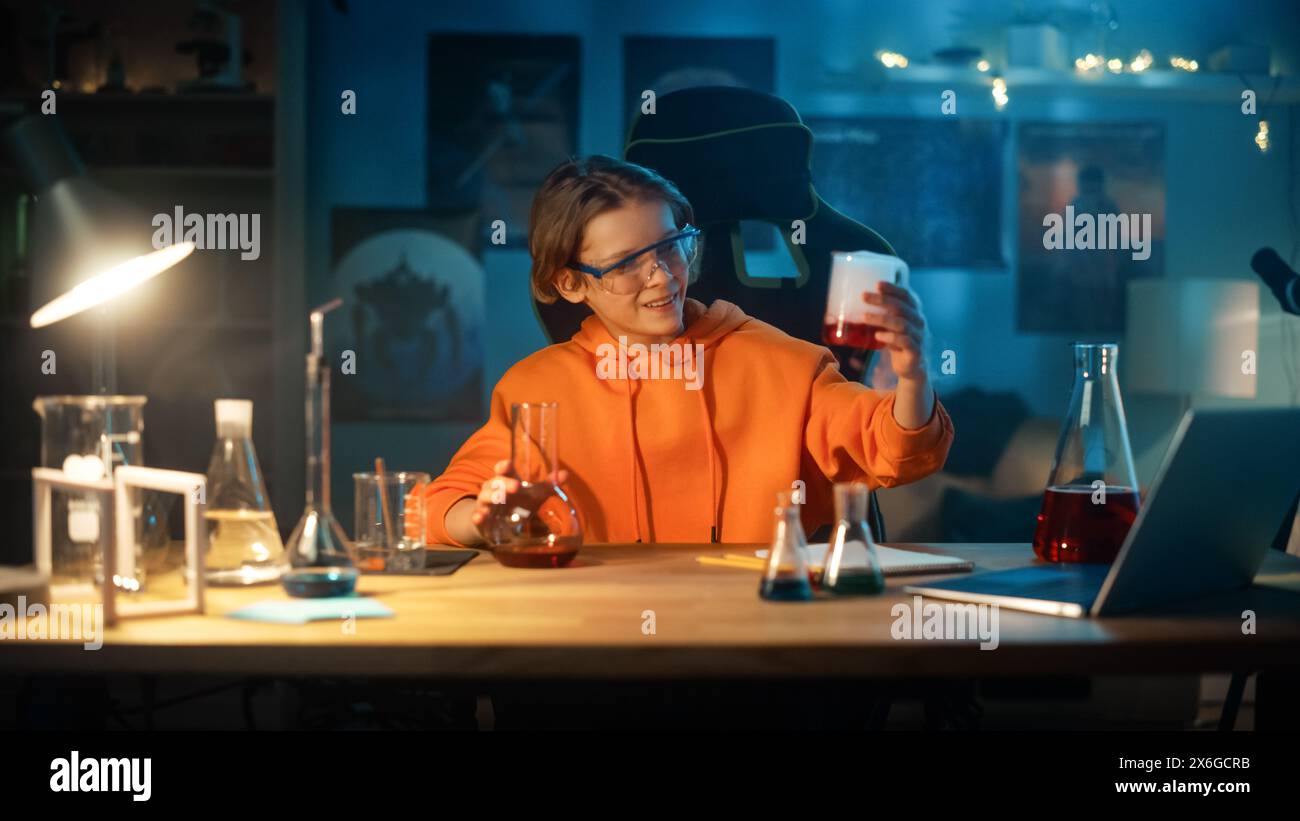 Smart Young Boy in Safety Glasses Mixes Chemicals in Beakers at Home ...