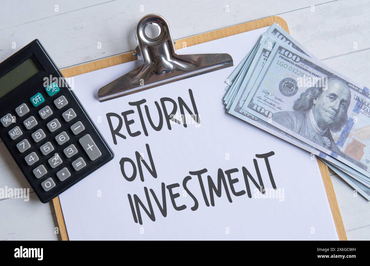 Top view image of calculator, money and paper clipboard with text ...