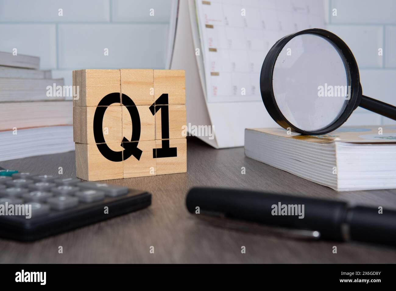 Close up image of wooden cubes with alphabet Q1 on office desk. First quarter concept Stock ...
