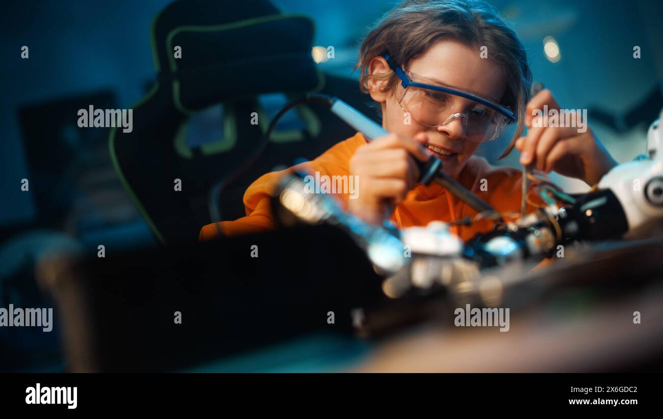 Smart Young Teenage Schoolboy is Studying Electronics and Soldering ...