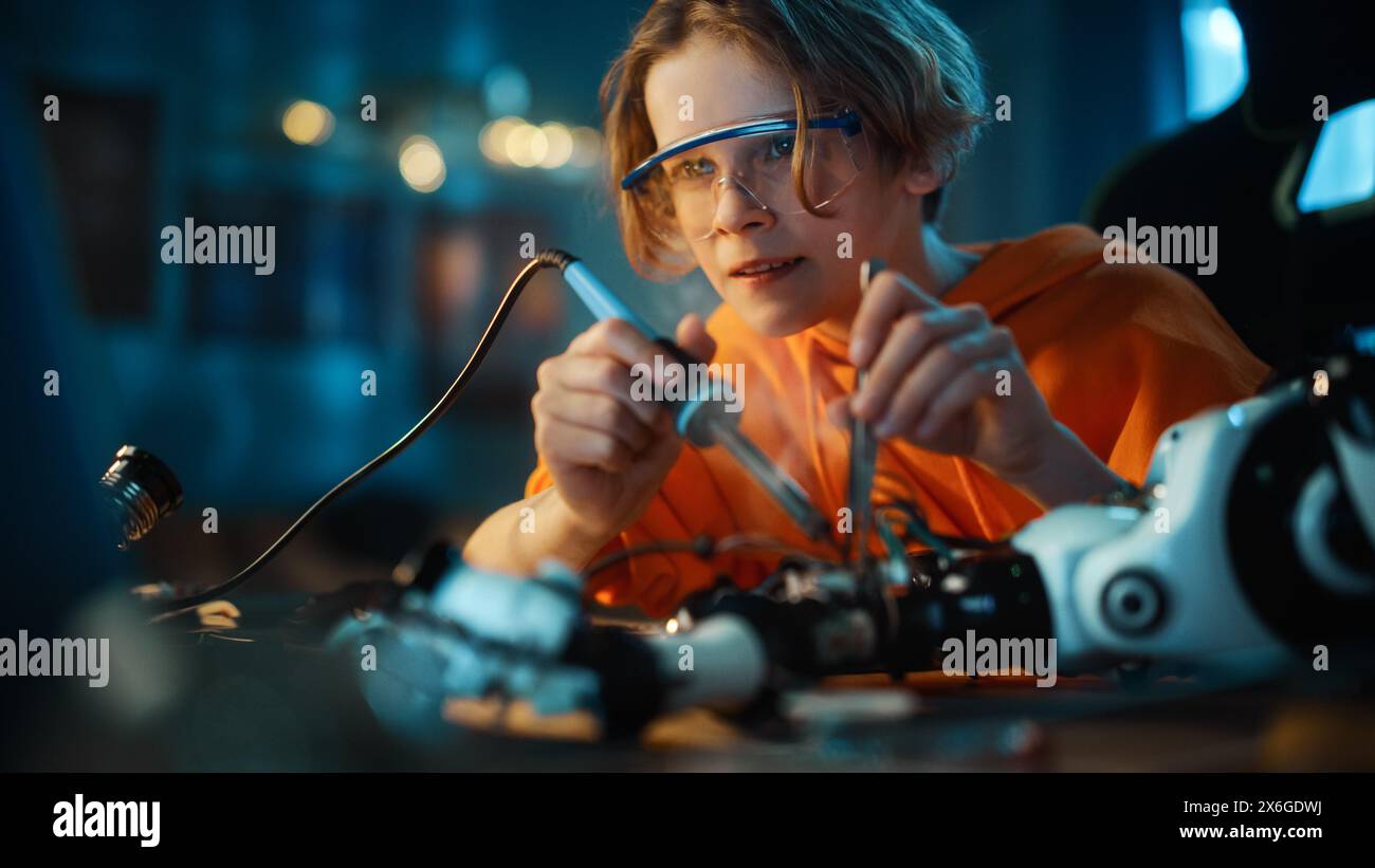 Smart Young Teenage Schoolboy is Studying Electronics and Soldering ...