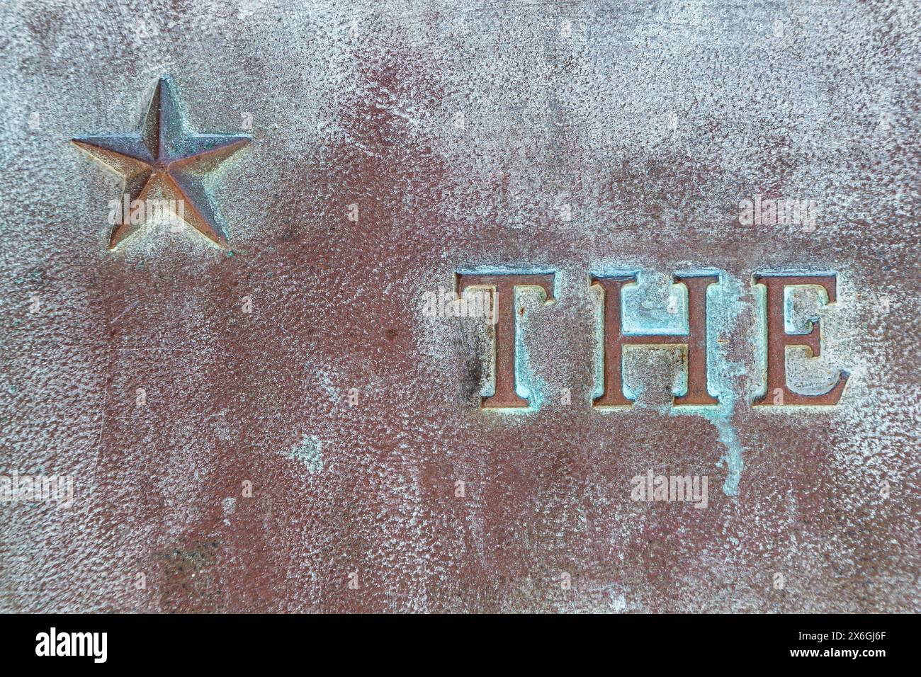 Star with patina. Star on a bronze monument. Inscription THE on a ...