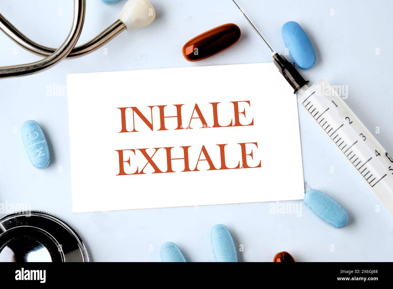 INHALE EXHALE written words on a business card on a blue background ...