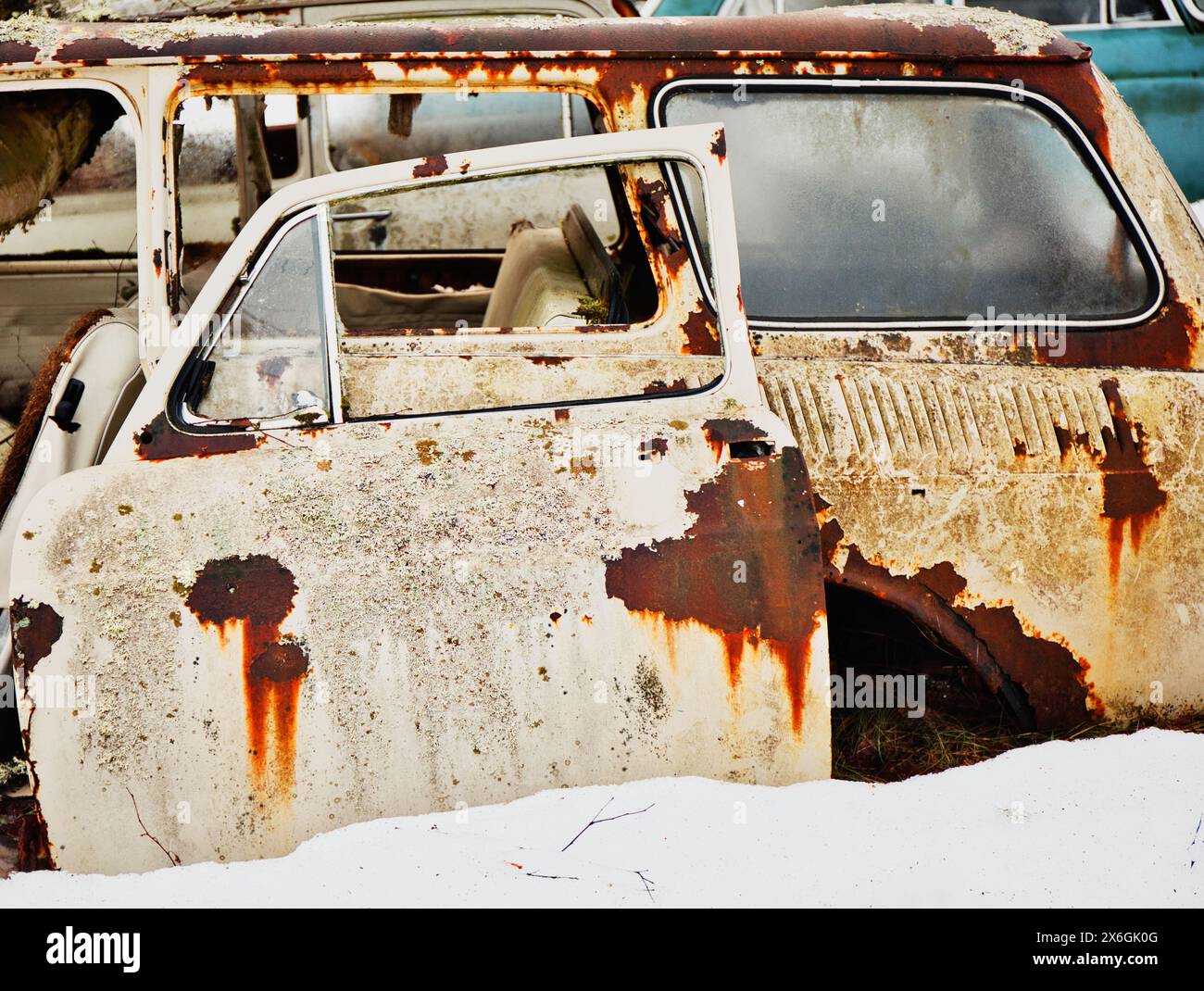Rusting abandoned, deserted, neglected classic vintage retro car automobile in deep snow ...