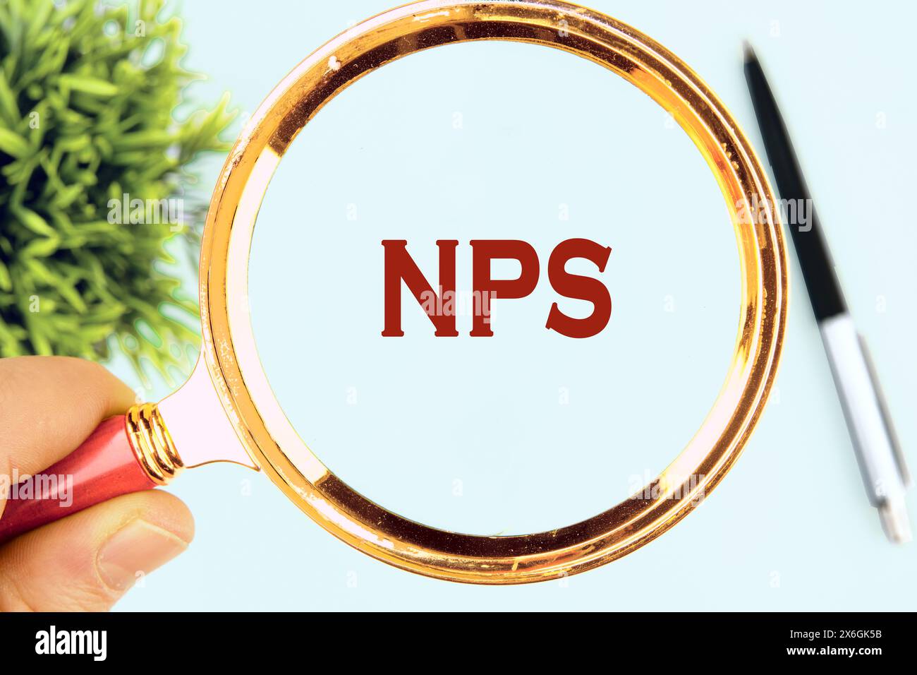 Concept word NPS Net Promoter Score written through a magnifying glass ...