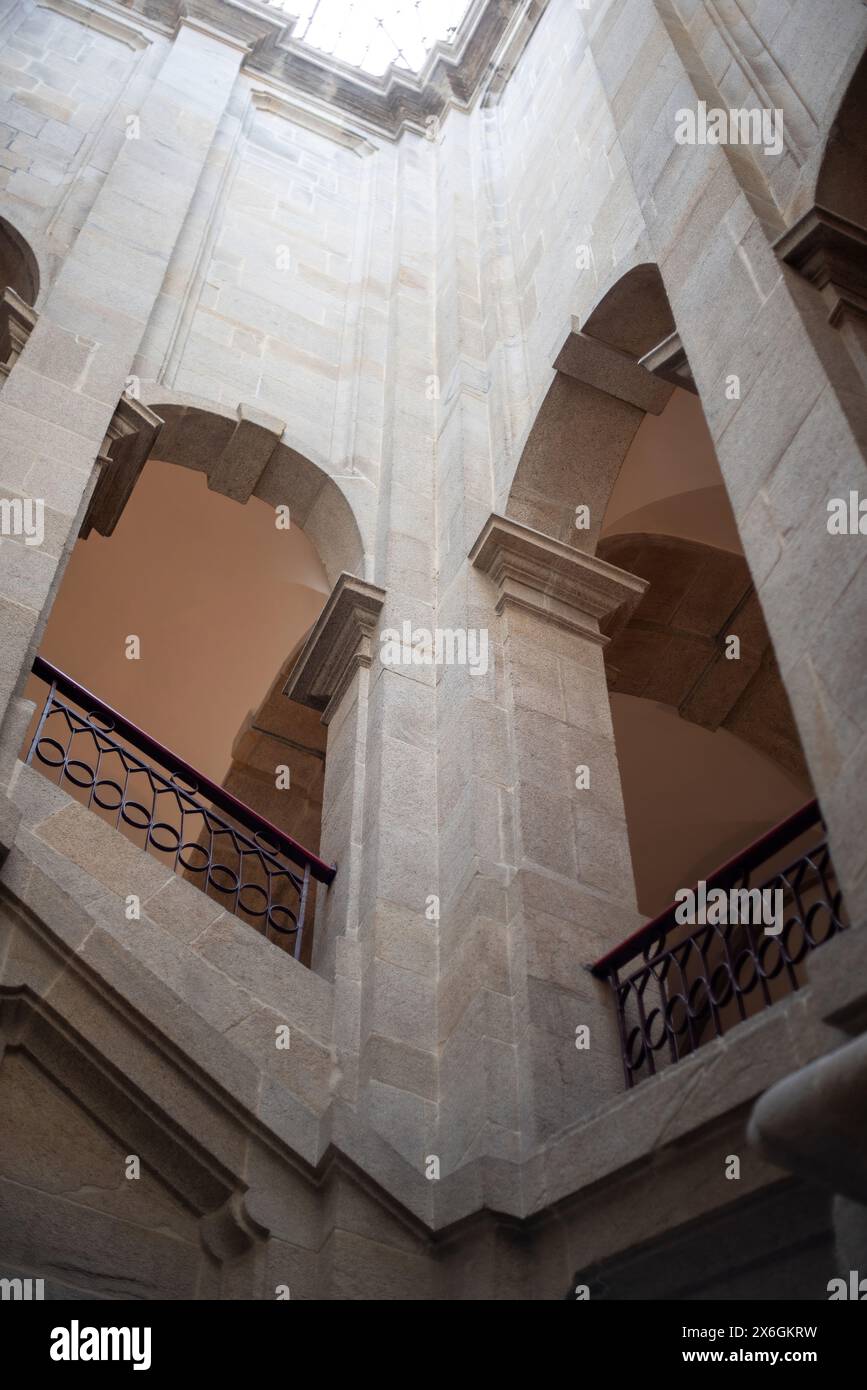 Interior of an ancient building with stairs, columns and arches ...