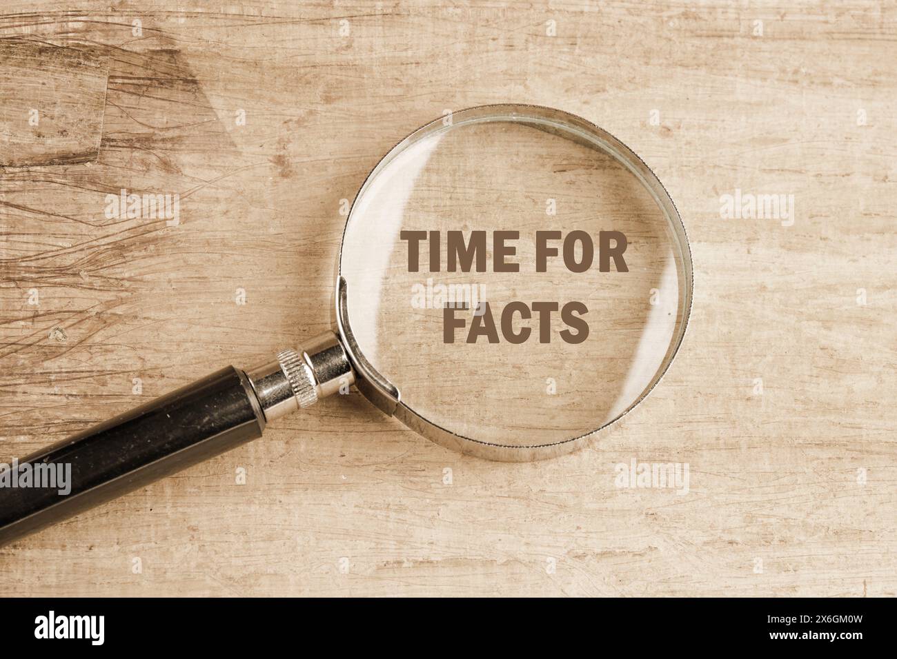Time for facts message written visible through a magnifying glass on an ...