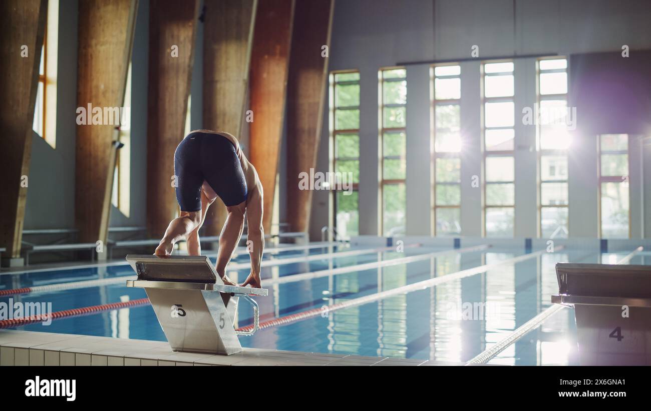 Muscular Mature Male Swimmer Standing on a Starting Block and ...