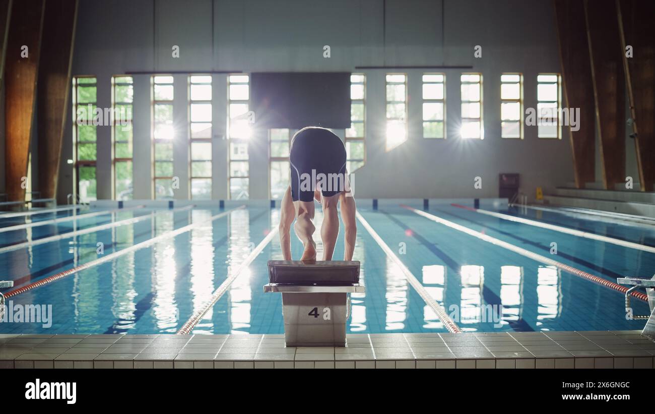 Athletic Male Swimmer Standing on a Starting Block, Ready to Jump into ...