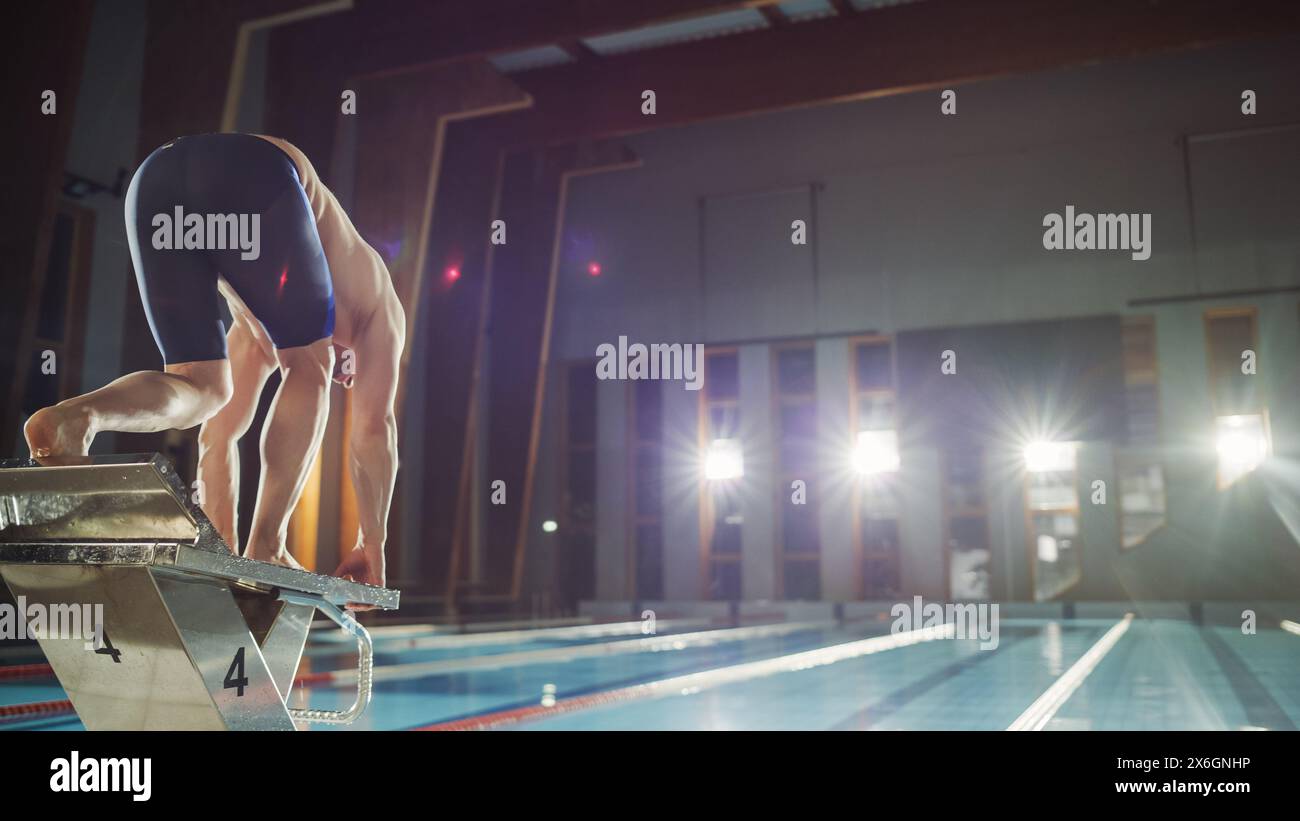Athletic Male Swimmer Stands on a Starting Block, Ready to Dive into ...