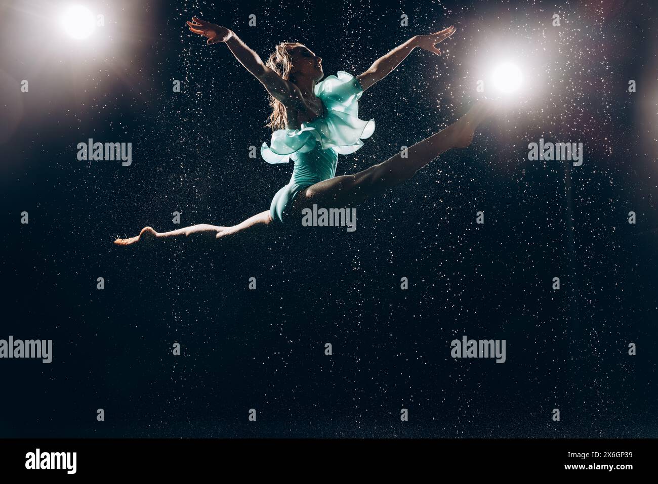 Ballerina teenager girl in green bodysuit bouncing and performing ...