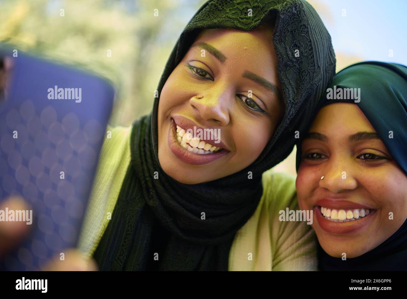 Middle Eastern Muslim Women Capturing Selfies in Serene Surroundings ...