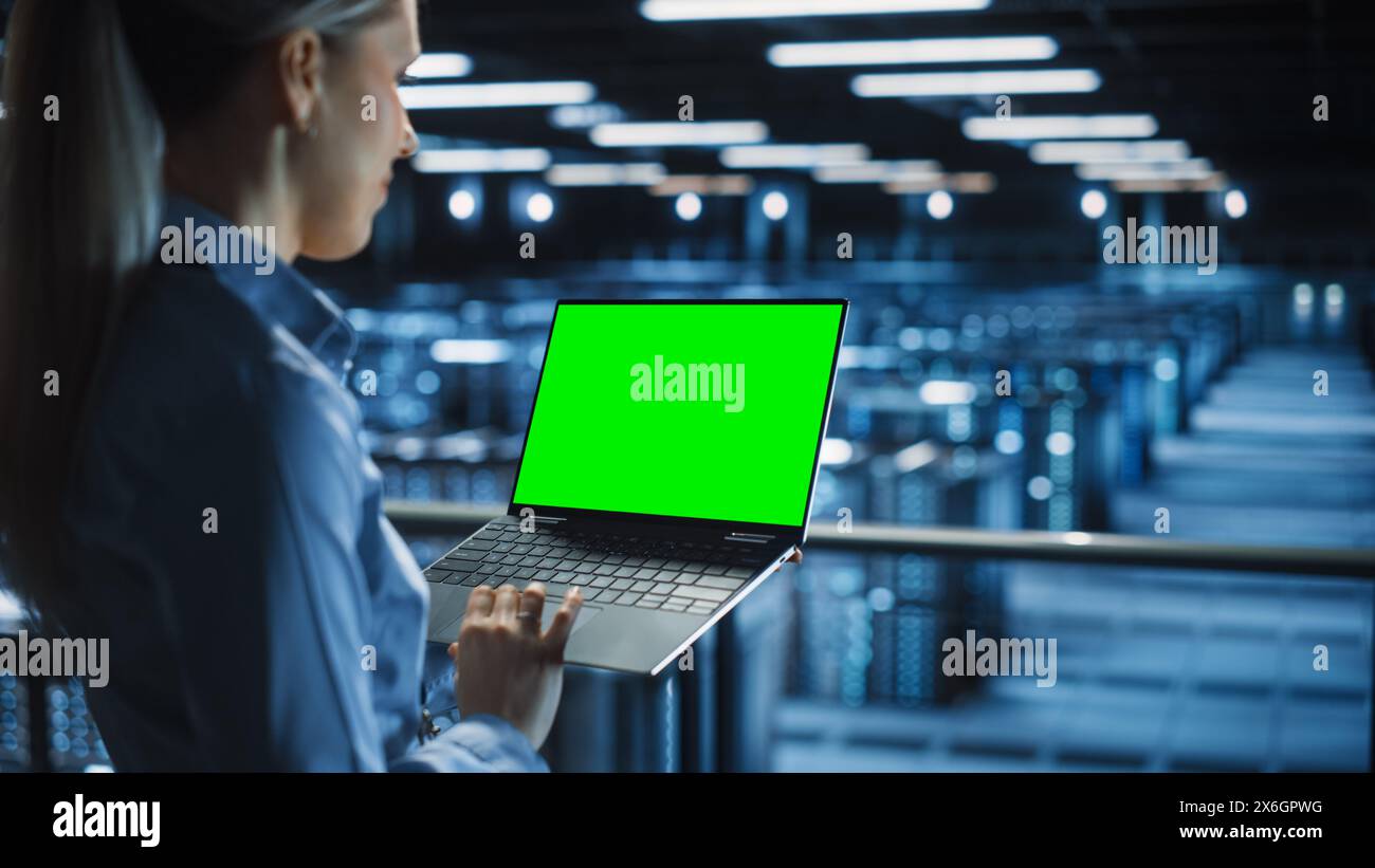 Female It Specialist Using Chroma Key Laptop in Data Center. Big Server Farm Cloud Computing ...