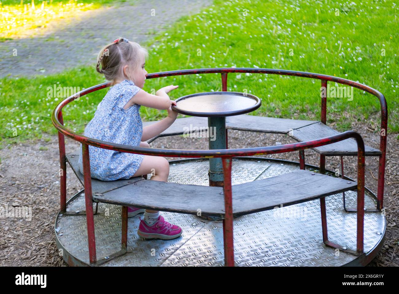 happy preschool girl, child spinning on carousel on summer day ...