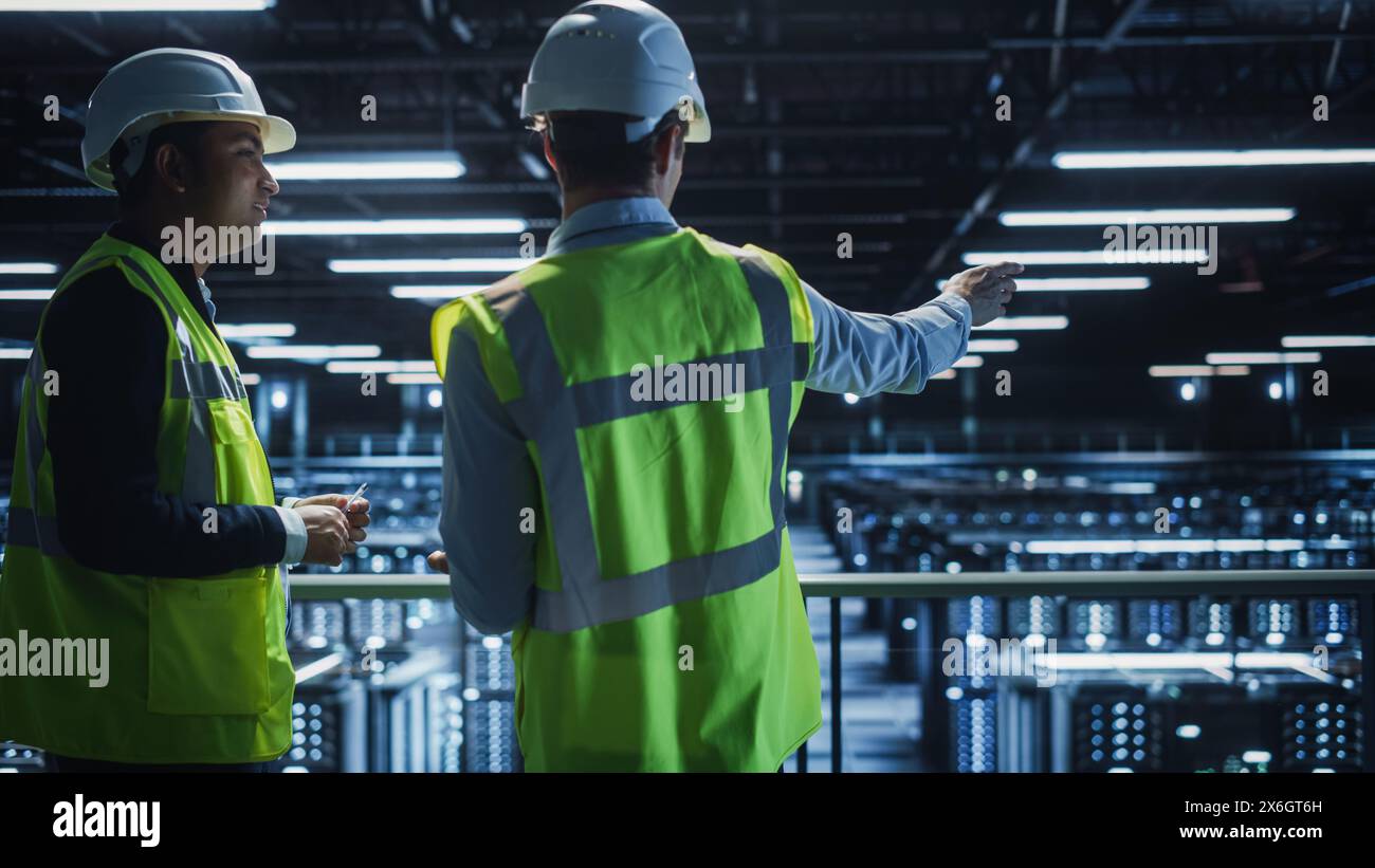 Multi ethnic engineers wearing safety hi-res stock photography and ...