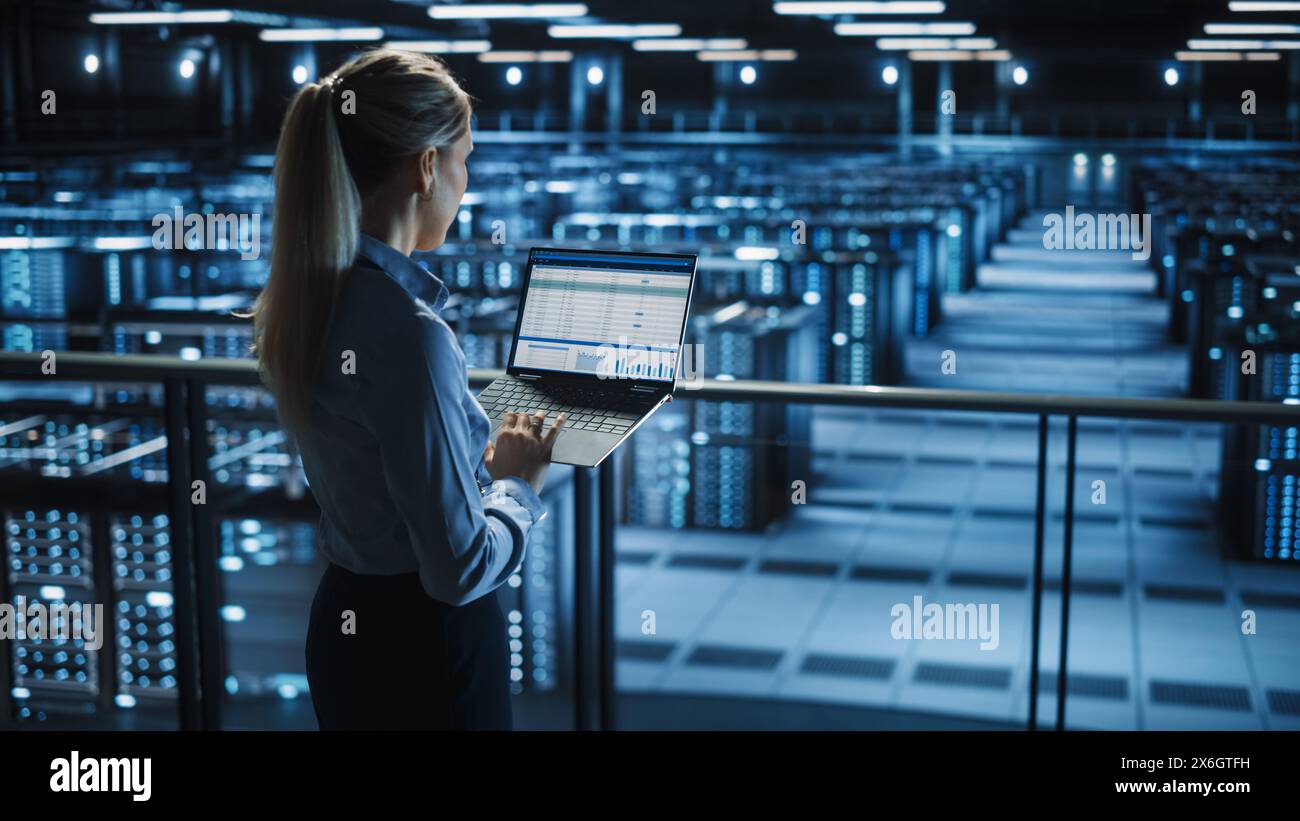 Data Center Female IT Specialist Uses Laptop Computer. Cloud Computing ...