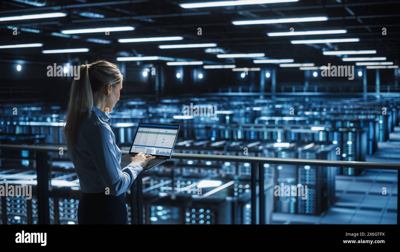 Data Center Female IT Specialist Uses Laptop Computer. Cloud Computing ...