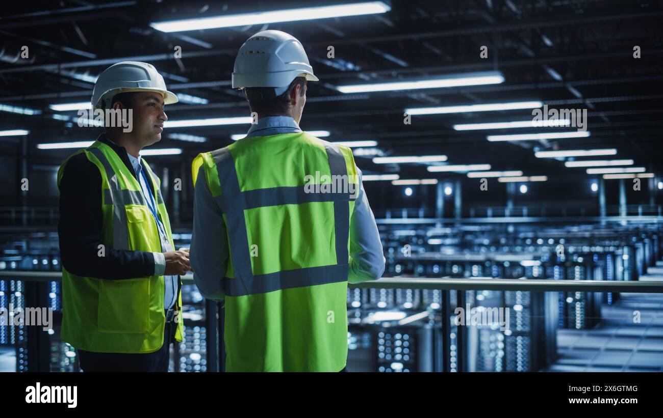 Multi ethnic engineers wearing safety hi-res stock photography and ...