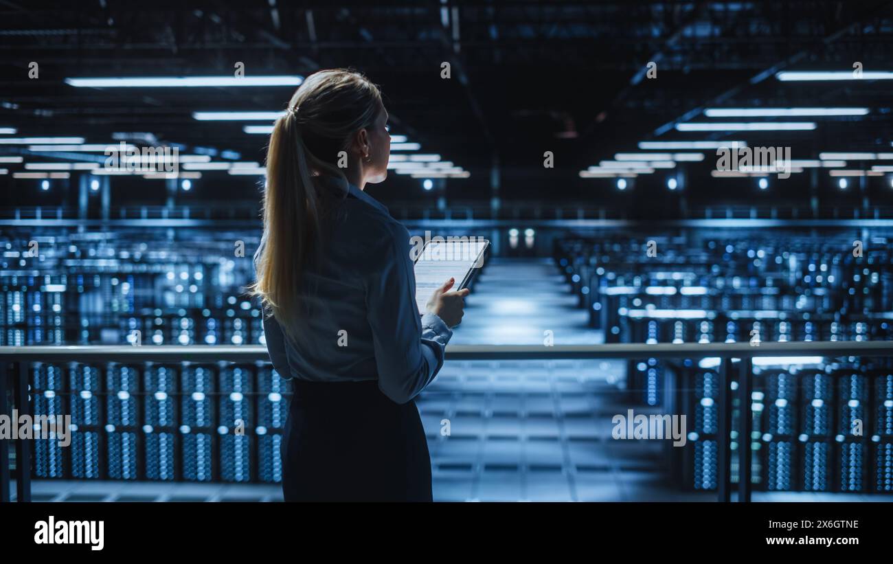 Data Center Female Programmer Using Tablet Computer, Maintenance IT Specialist. In Cloud ...