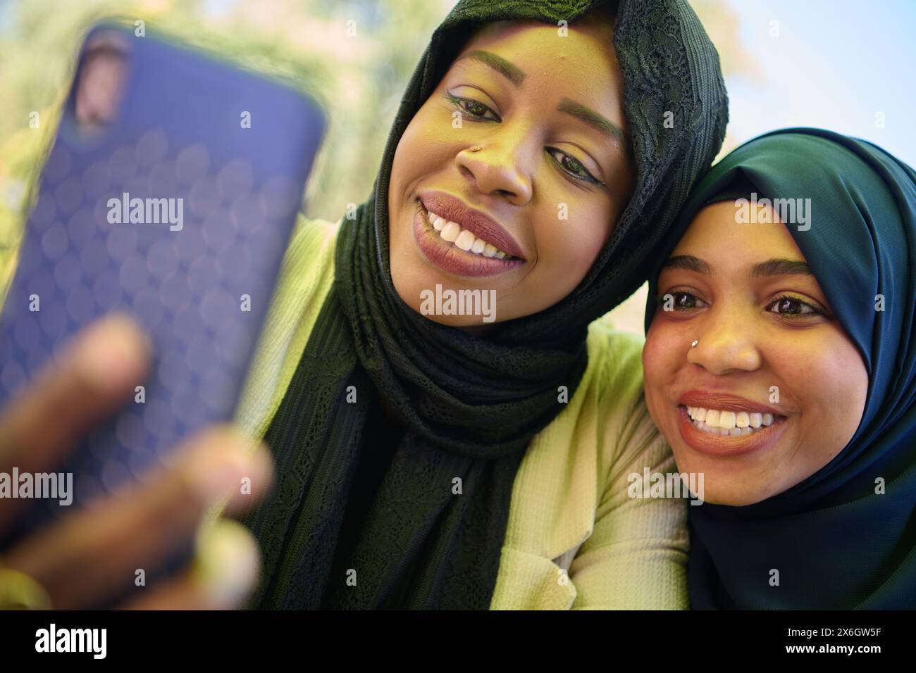 Middle Eastern Muslim Women Capturing Selfies in Serene Surroundings ...