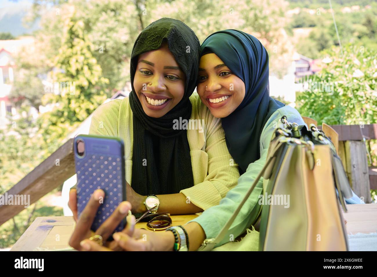 Middle Eastern Muslim Women Capturing Selfies in Serene Surroundings ...