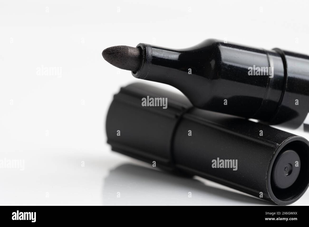 Closeup black marker pen isolated on white background Stock Photo - Alamy