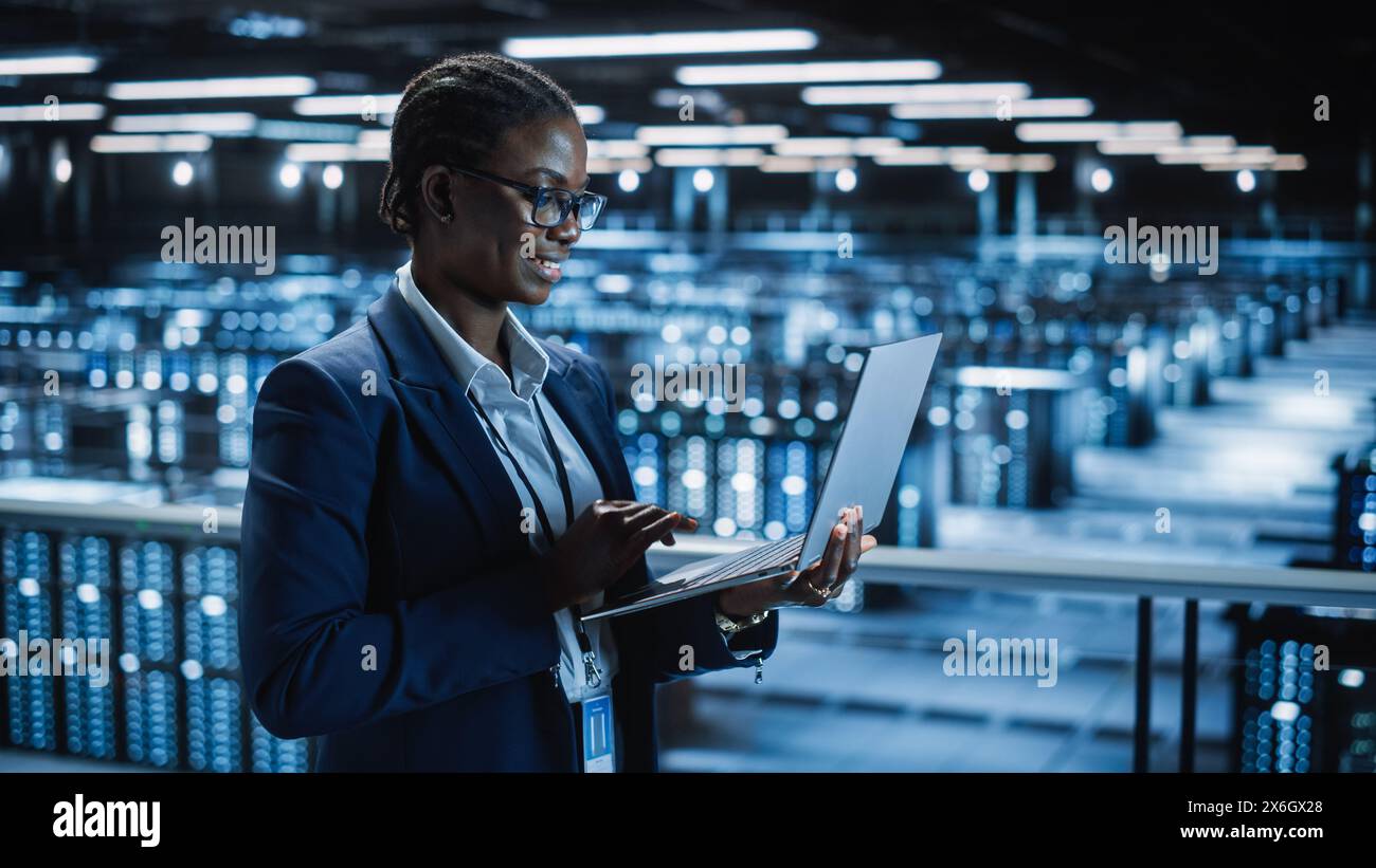 Data Center Female Programmer Using Laptop Computer, Maintenance IT Specialist. In Cloud ...