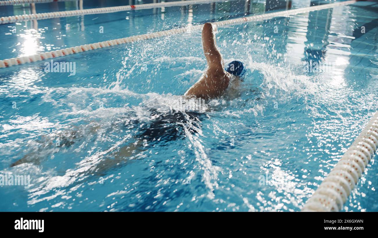 Male Swimmer Swimming in Olympic Pool. Professional Athlete Performing at Championship, using ...