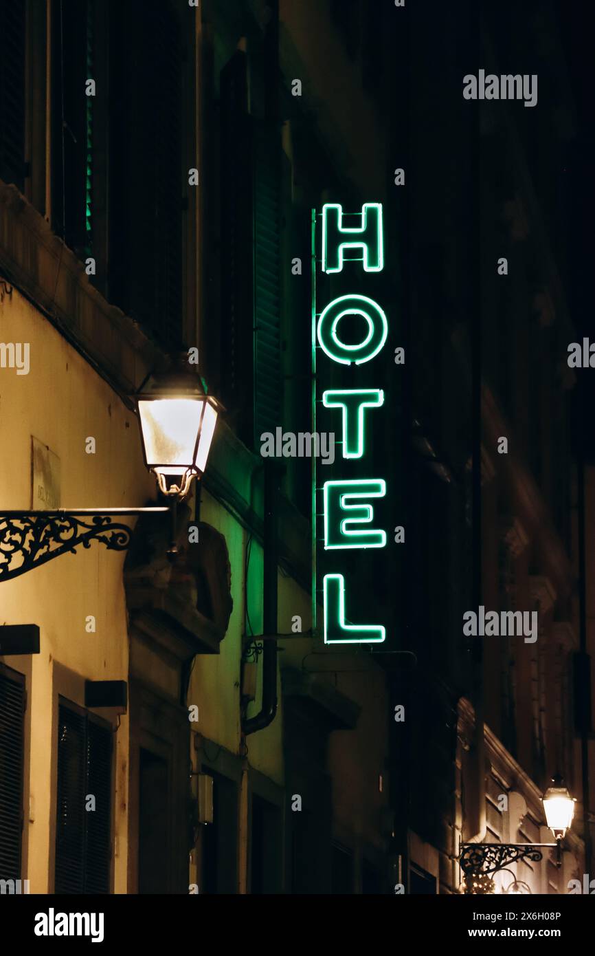 Neon sign of a hotel on the street at night Stock Photo - Alamy
