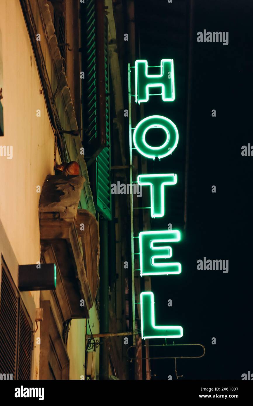 Neon sign of a hotel on the street at night Stock Photo - Alamy