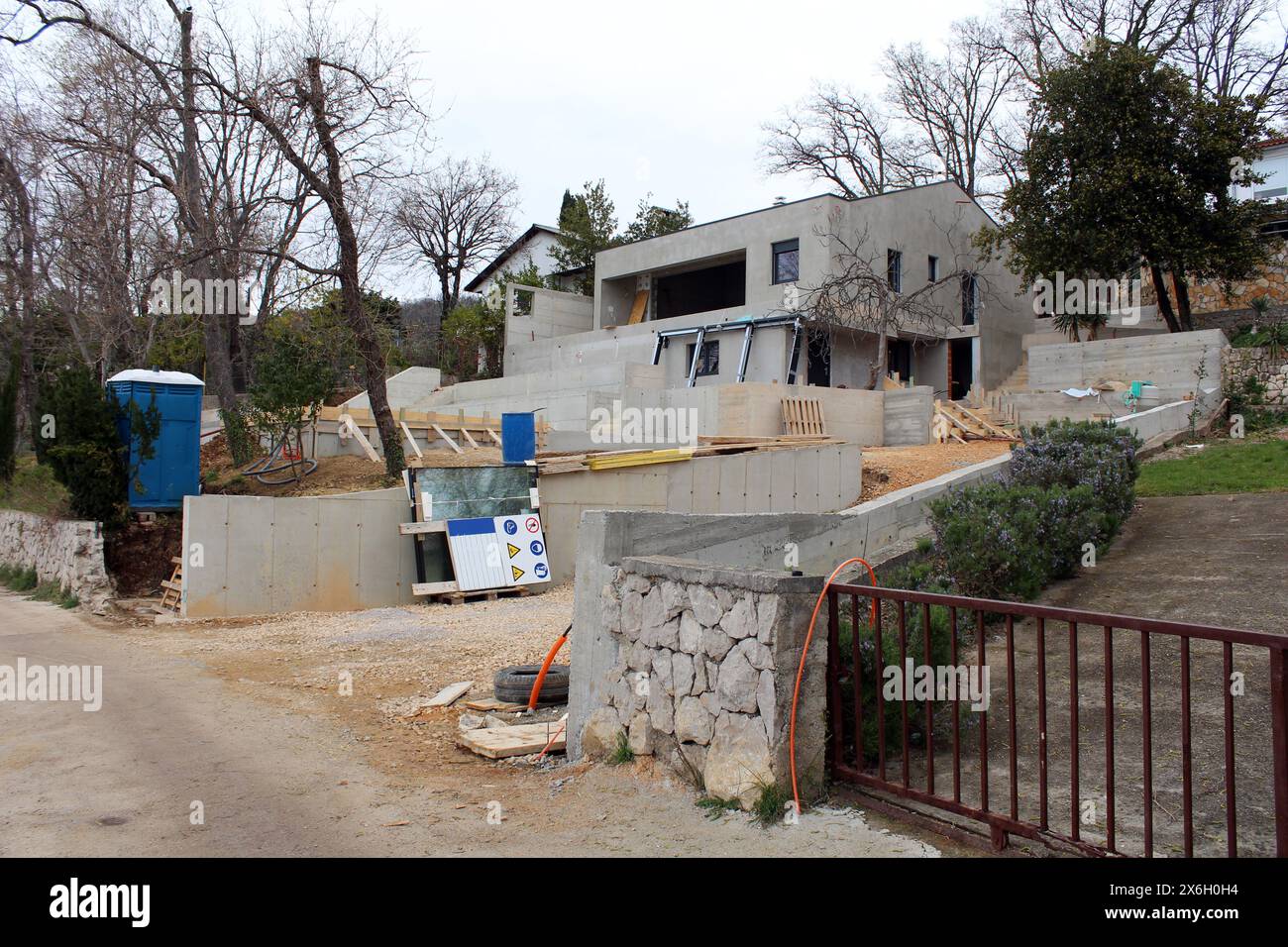 Construction site for modern villa by the sea filled with construction ...