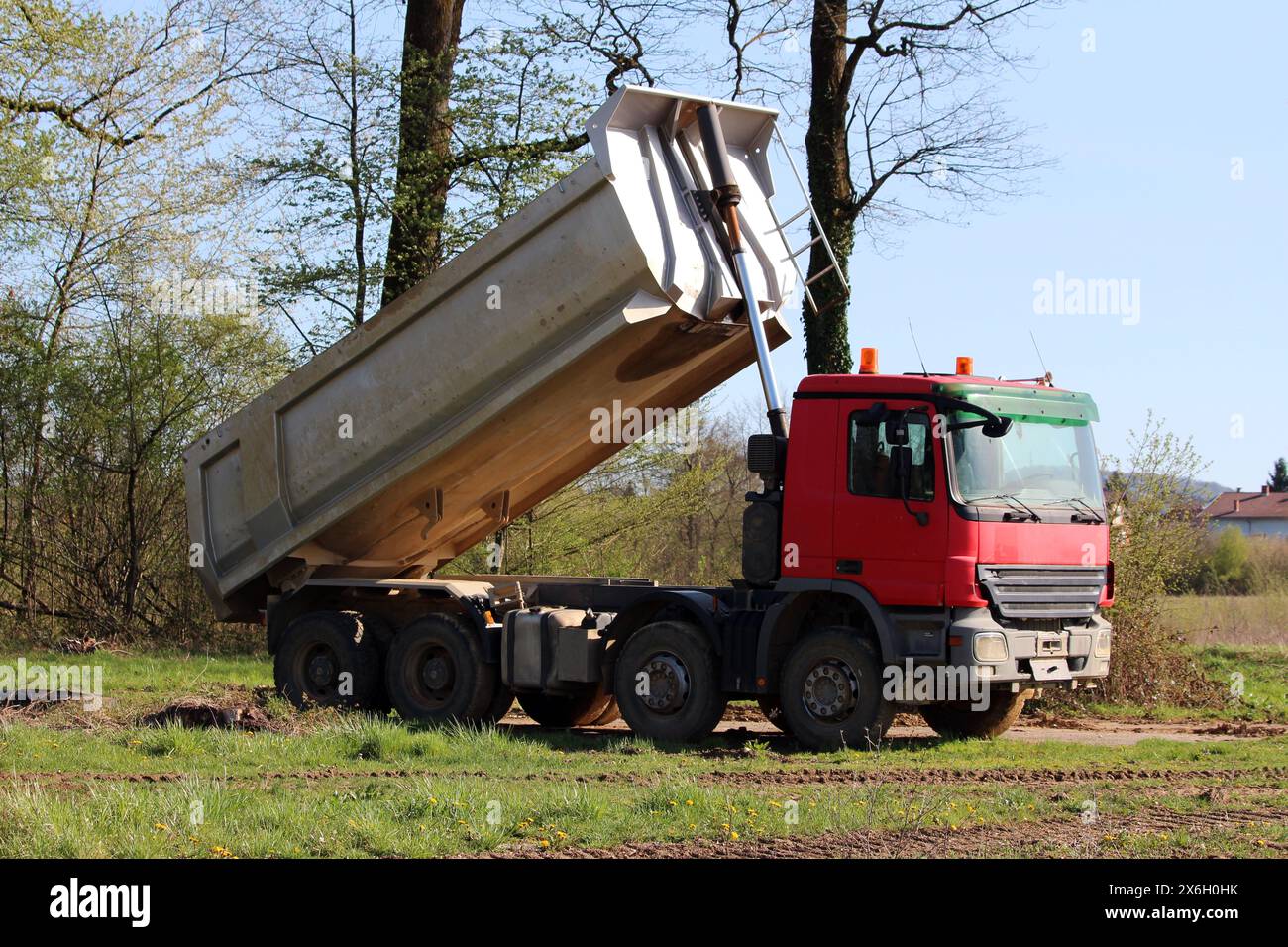 Parked rigid chassis three way heavy duty tipper truck with lifted open ...