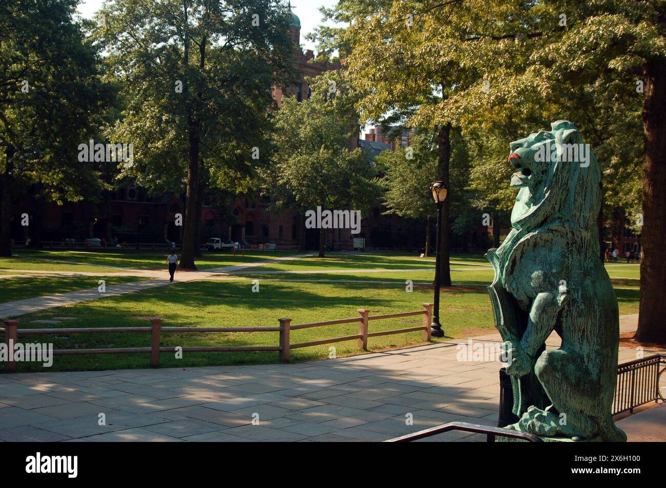 A sculpture of a lion looks over the yard and campus of Yale University ...
