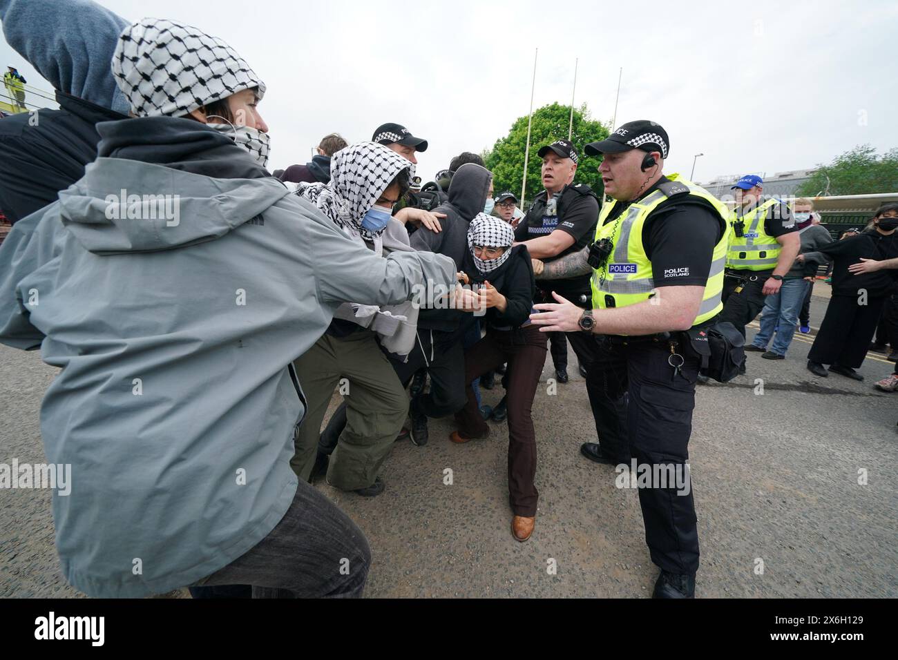 Pro-Palestine campaigners scuffle with police during a protest outside ...