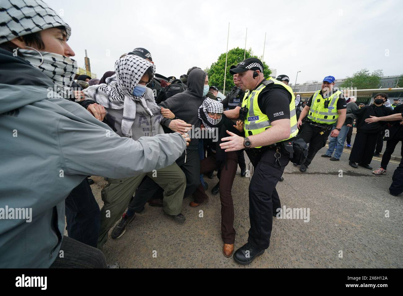 Pro-Palestine campaigners scuffle with police during a protest outside ...