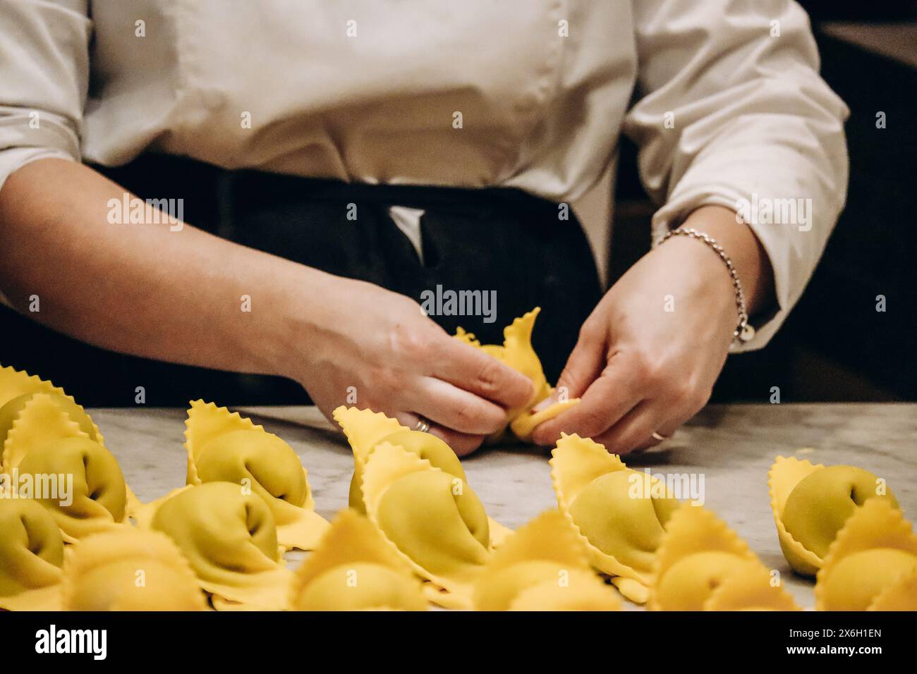 The chef prepares the cappellacci with ricotta and spinach Stock Photo ...